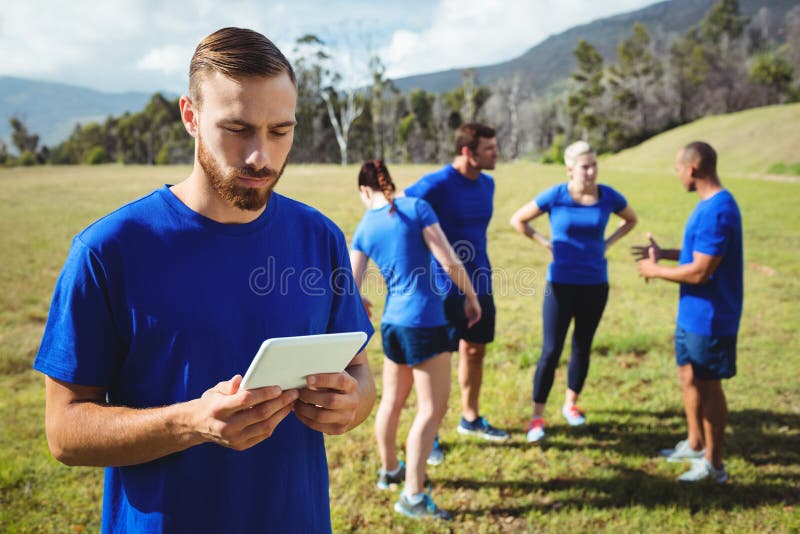 Man Using Digital Tablet in Boot Camp Stock Photo - Image of camp ...