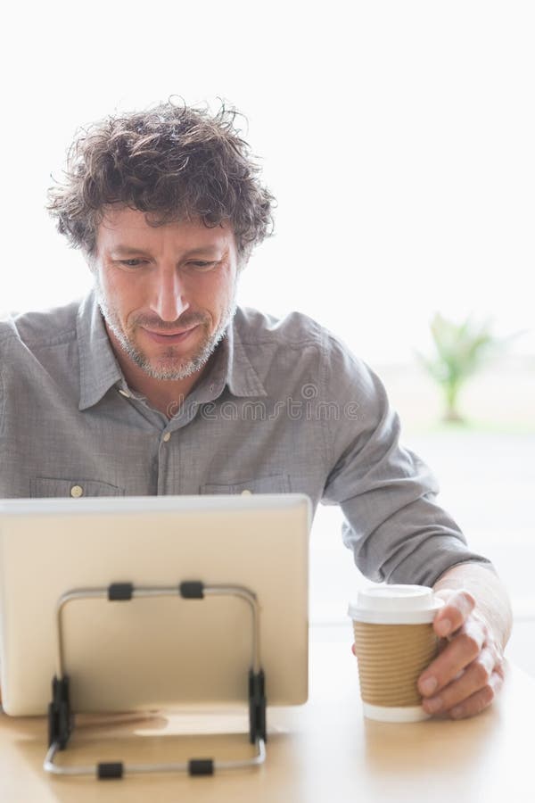 Man using digital tablet stock image. Image of drink - 77723625