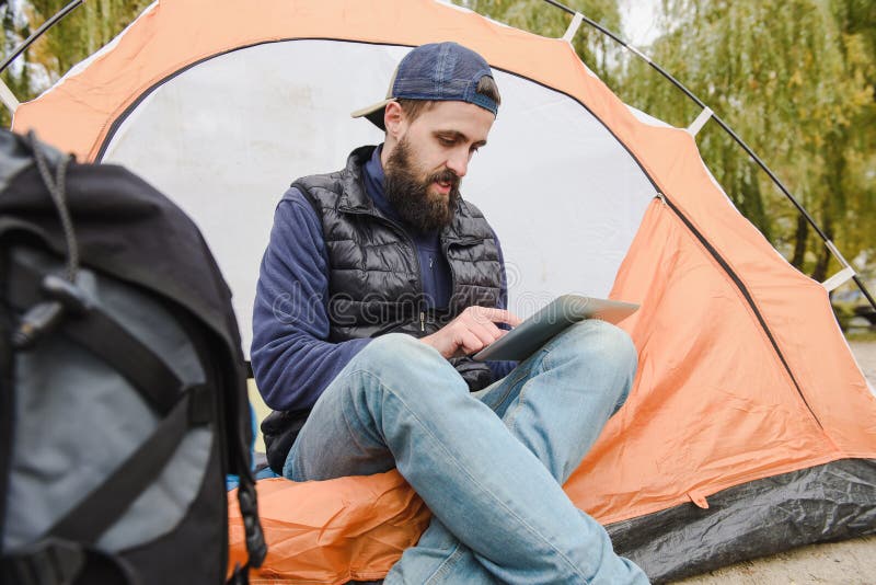 Man Using Digital Tablet in Camping Tent Stock Photo - Image of ...