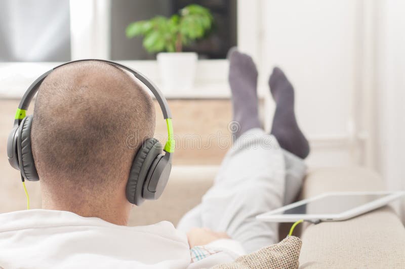 Man Using Digital Tablet Computer at Home Wearing Headphones Stock ...