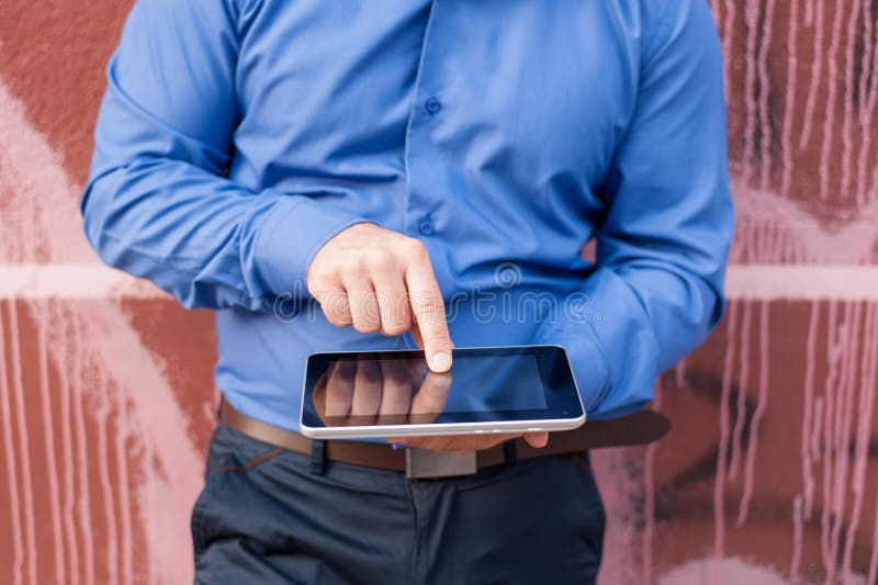 Man Using Digital Tablet and Leaning on Wall Outdoors Stock Photo ...