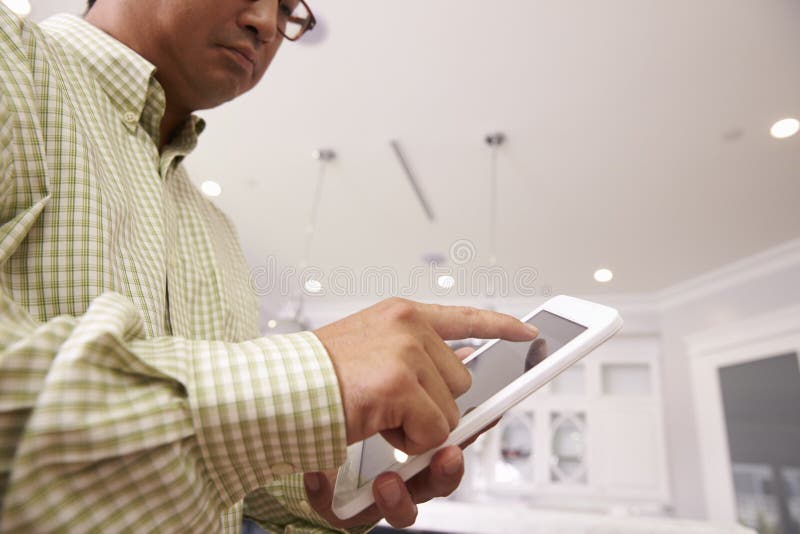 Man Using Digital Tablet To Control Lighting at Home Stock Photo ...
