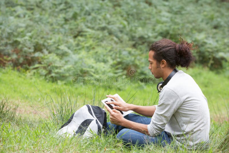 Man Using Digital Tablet Whilst Hiking in Countryside Stock Photo ...