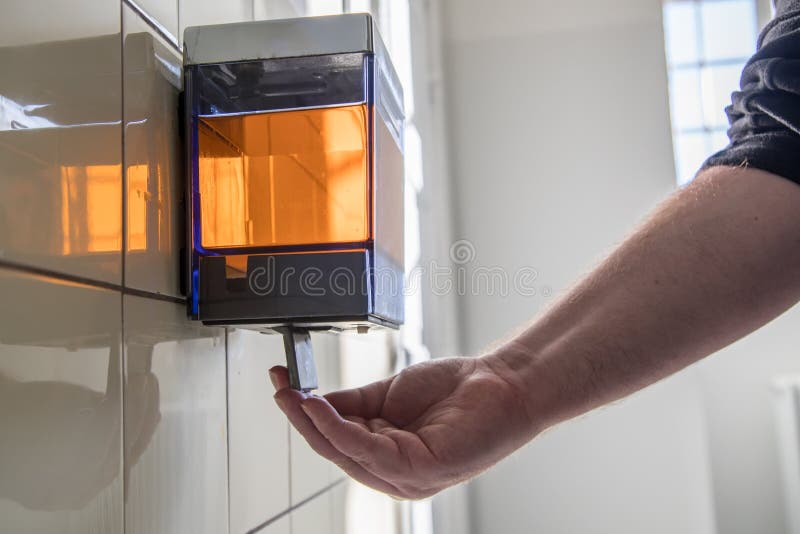 Man Using Dispenser with Liquid Soap for Washing Hands Stock Photo ...