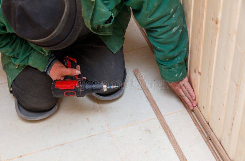 A Man is Using a Drill To Make a Hole in a Wall Stock Image - Image of ...