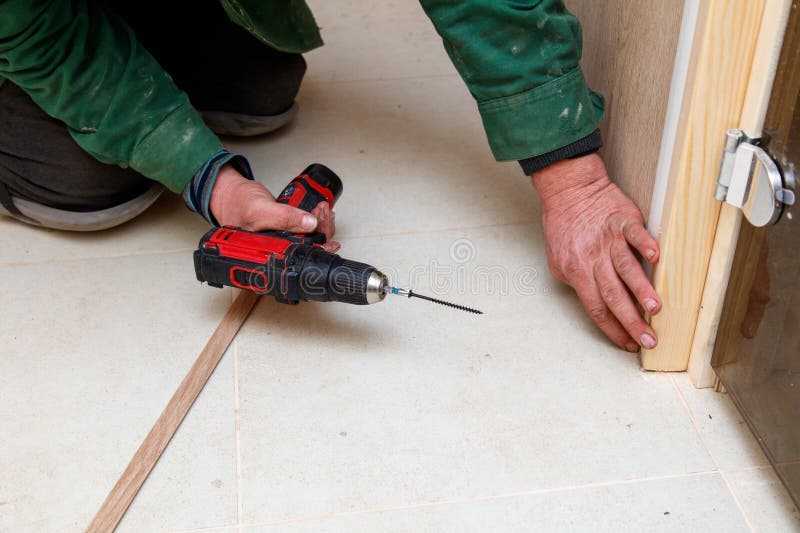 A Man is Using a Drill To Make a Hole in a Wall Stock Photo - Image of ...