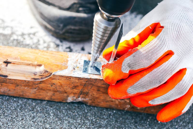 Man is Using a Drill To Make a Hole in a Wooden Board Stock Photo ...