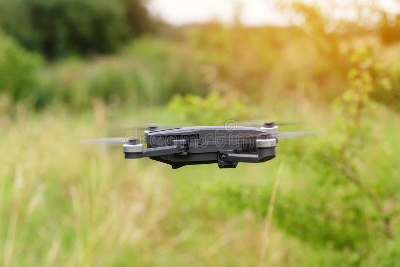 Man Using a Drone with Remote Controller Making Photos and Videos, with ...