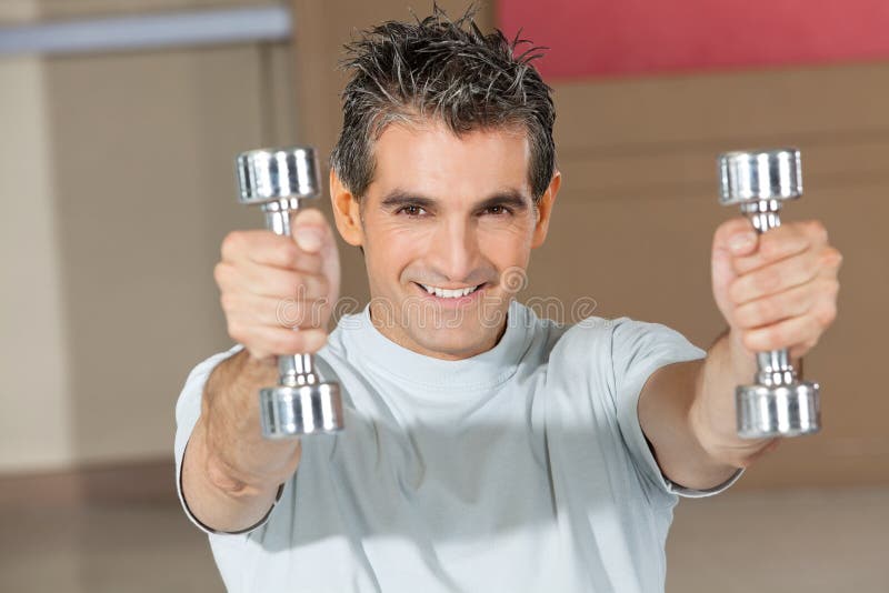 Man Using Dumbbells in Fitness Stock Image - Image of person, dumbbells ...