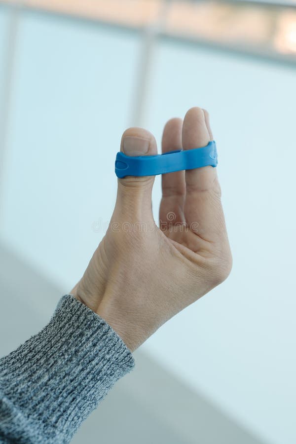 Man Using an Elastic Band To Exercise His Fingers Stock Photo - Image ...