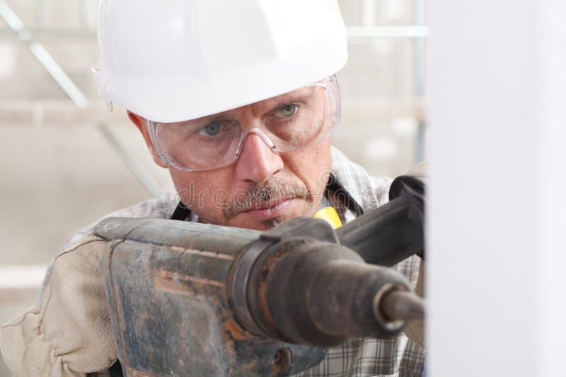 Man Using an Electric Pneumatic Drill Making a Hole in Wall ...
