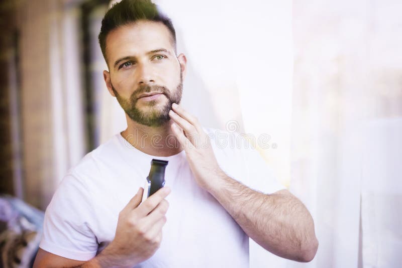 Man Using Electric Razor at Home Stock Photo - Image of life, care ...