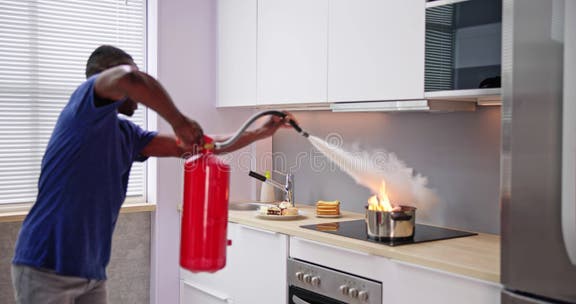 Man Using Fire Extinguisher To Stop Fire Stock Photo - Image of african ...