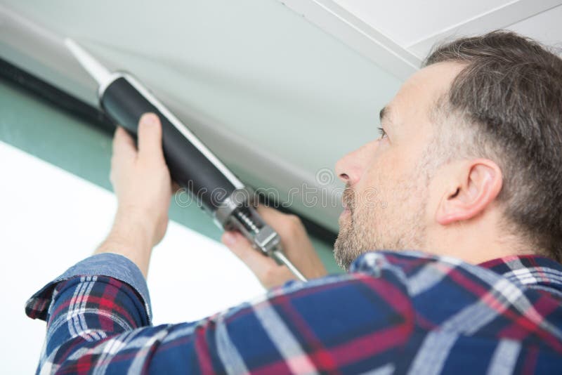 Man using gun with silicon stock image. Image of instrument - 248309841