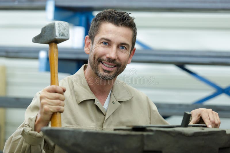 Man Using Hammer in Factory Stock Photo - Image of tool, labour: 214071432