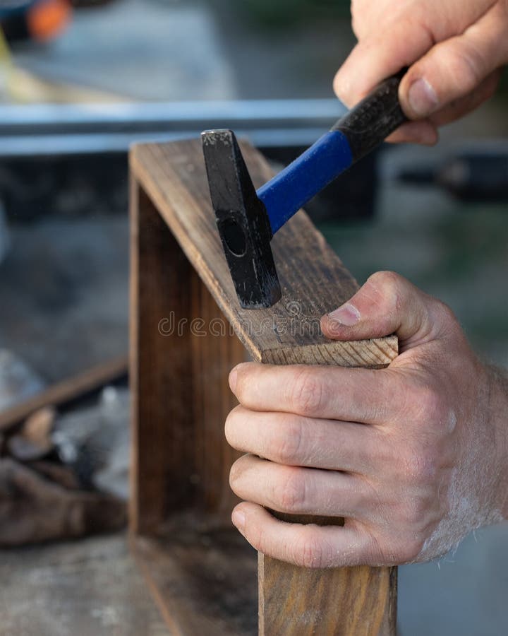 Man Using Hammer and Nail on Wood, Close Up Stock Photo - Image of ...