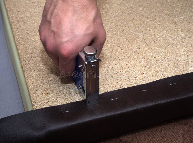 Man Using Hand-tool Stapler and Leatherette Upholstering Particle Board ...