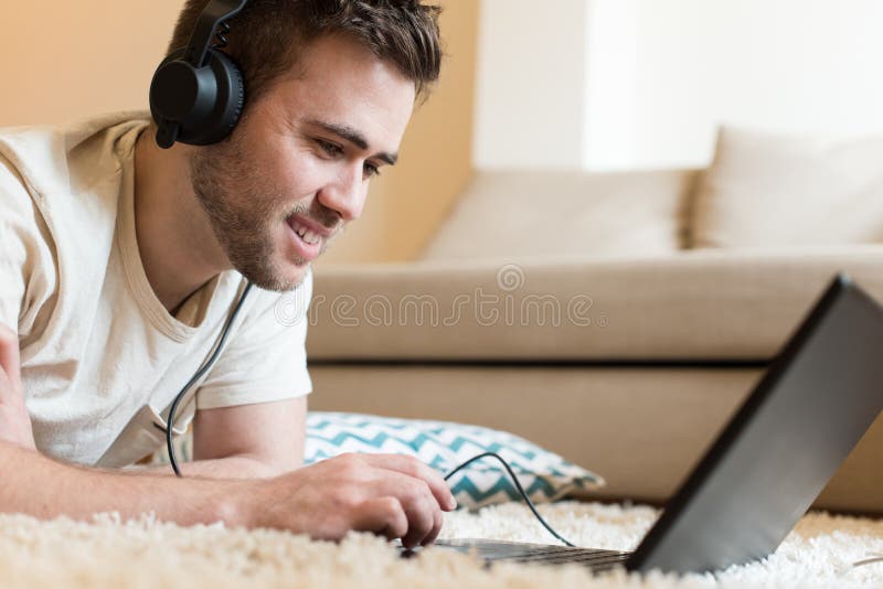 Man using headphones stock photo. Image of living, laptop - 52062002
