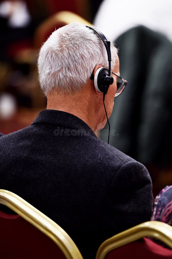 Man Using Translation Headphones Stock Photo - Image of head, event ...