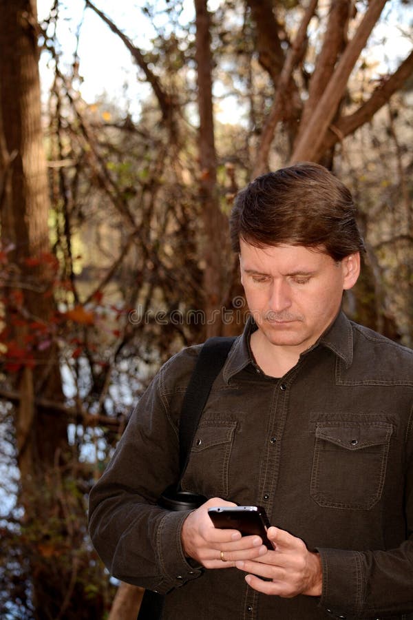 Man using his cellphone. stock image. Image of outdoors - 48140697