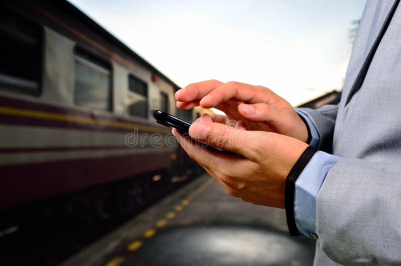 Man Using His Mobile Phone on Empty Railway Platform. Close-up H Stock ...