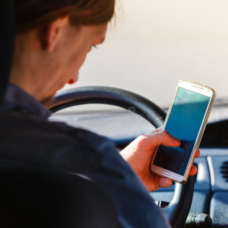 Man Using His Phone while Driving Car. Stock Photo - Image of drive ...