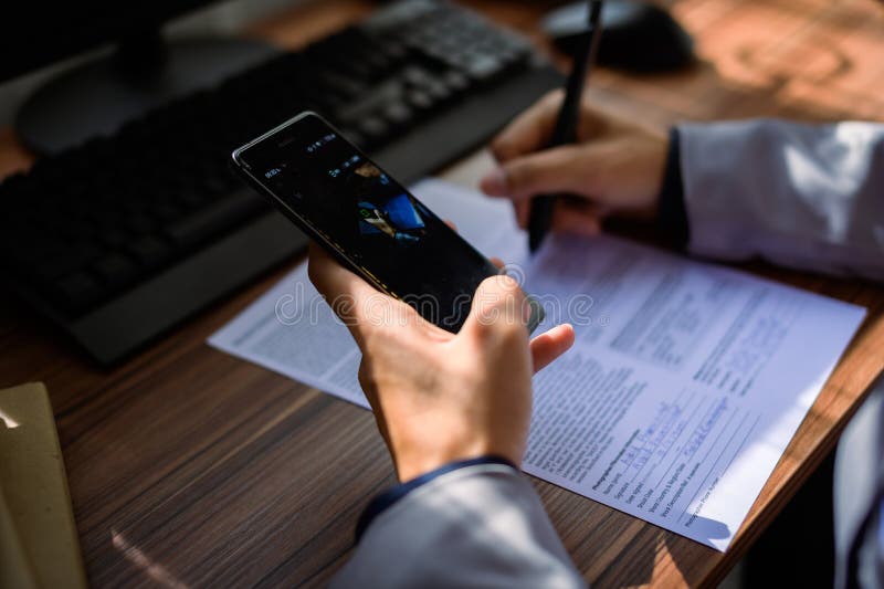 Businessman Reading and Writing Documents at Work Stock Photo - Image ...