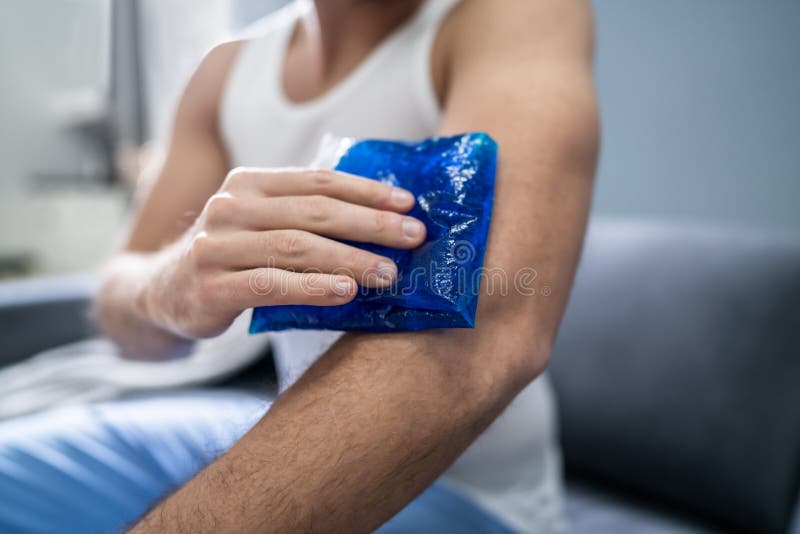 Man Using Ice Gel Pack on Arm Stock Image - Image of joint, pack: 219343947