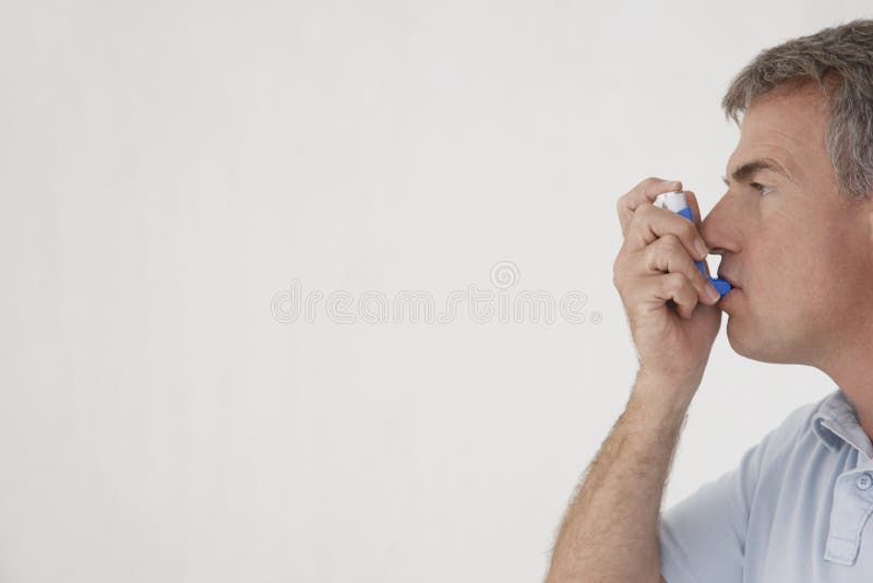 Man Using an Inhaler stock image. Image of asthma, holding - 7772237