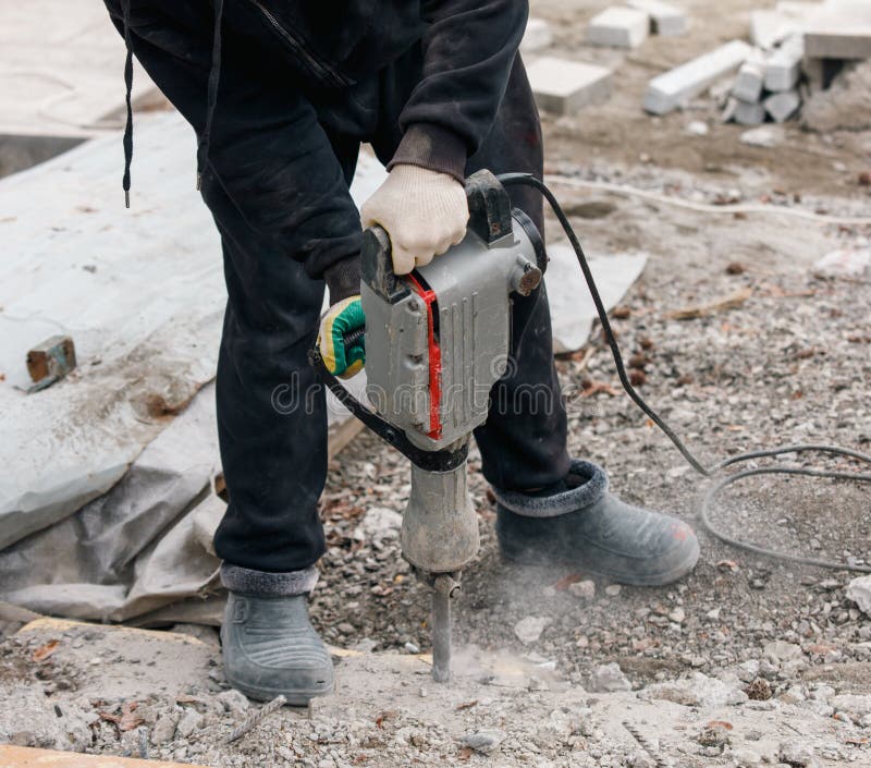 A Man is Using a Jackhammer To Break Up Concrete Stock Photo - Image of ...