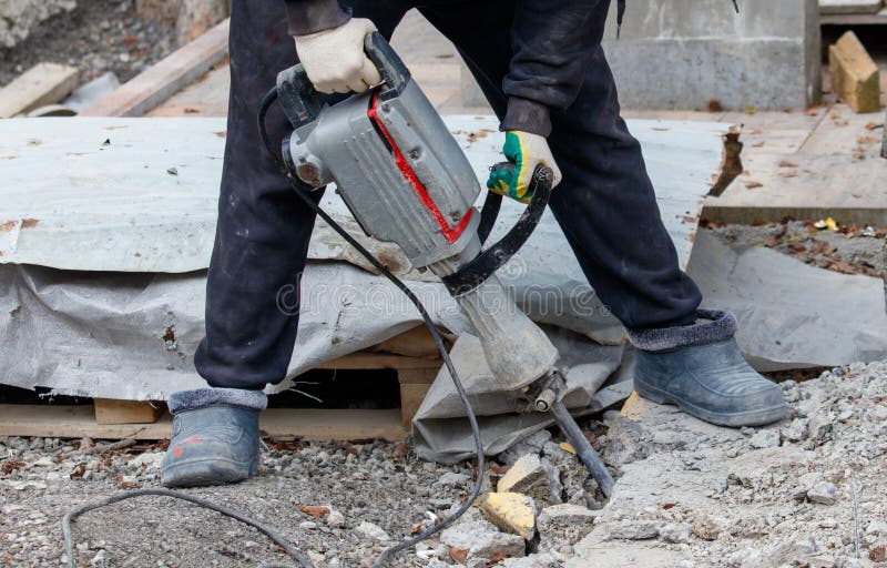 A Worker Using A Jackhammer Breaking Up Concrete Wall Stock Photos ...