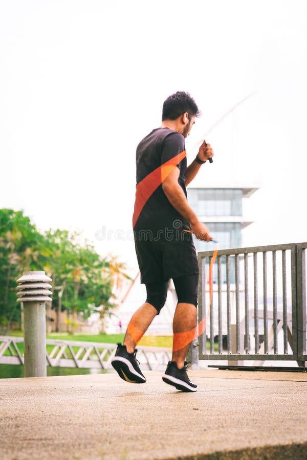 Man Using Jumping Rope Outdoors. View from Behind. Stock Image - Image ...
