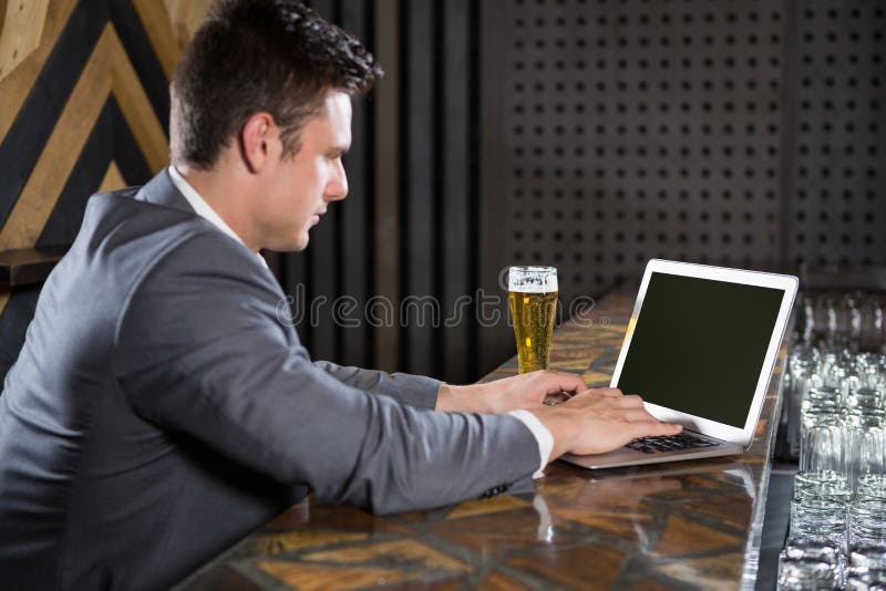 Man Using Laptop in Bar Counter Stock Photo - Image of suit, nightclub ...