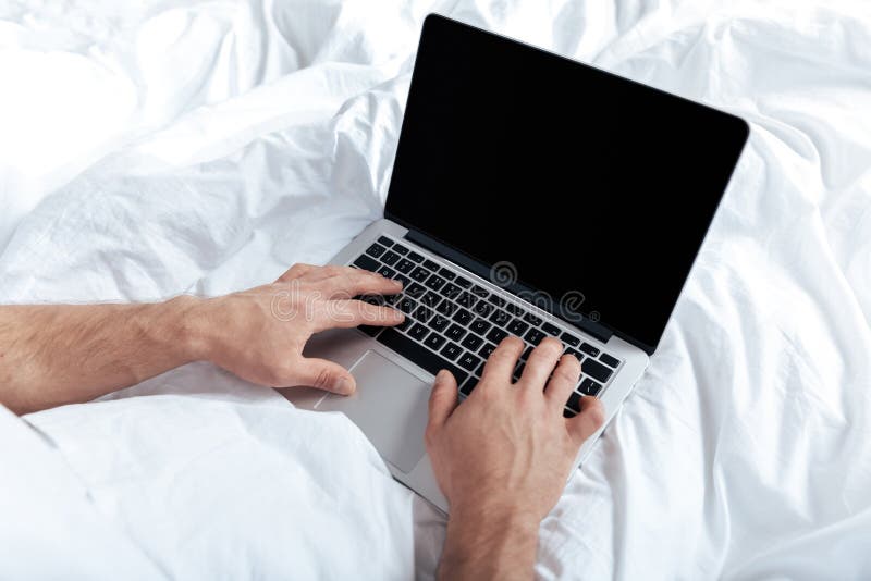 Man using laptop in bed stock photo. Image of handsome - 97153948