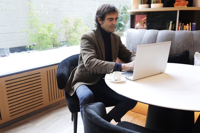 Man Using Laptop in a Cafe Bar Stock Photo - Image of looking ...