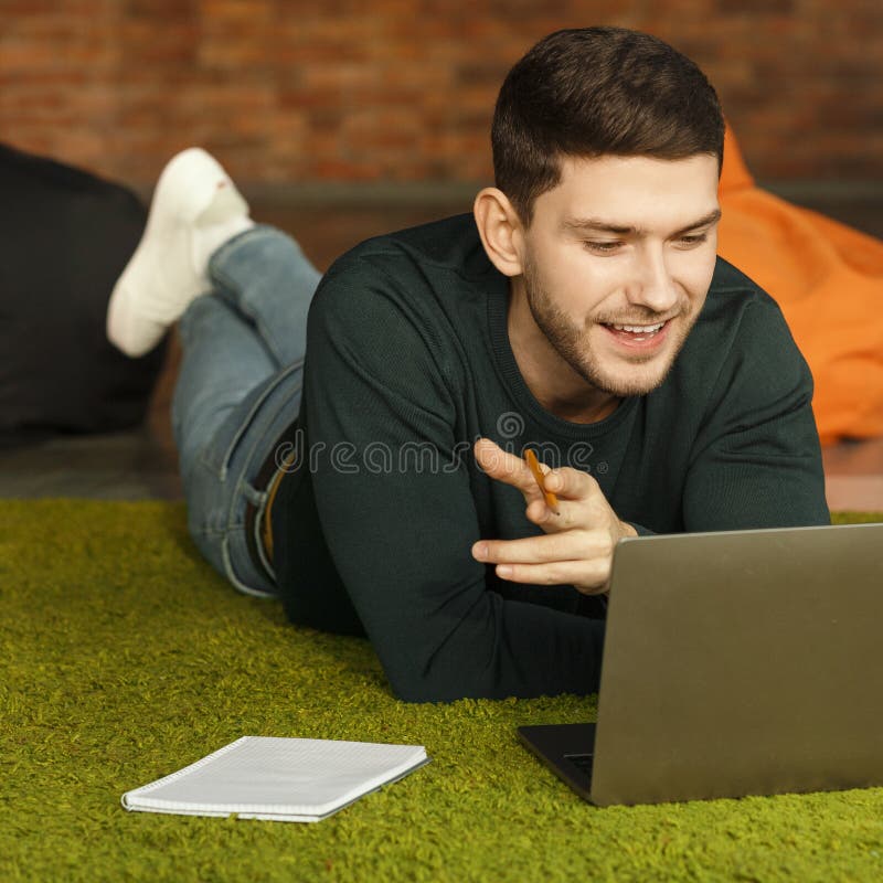 Man Using Laptop Communicating with Clients Lying on Floor Indoor Stock ...