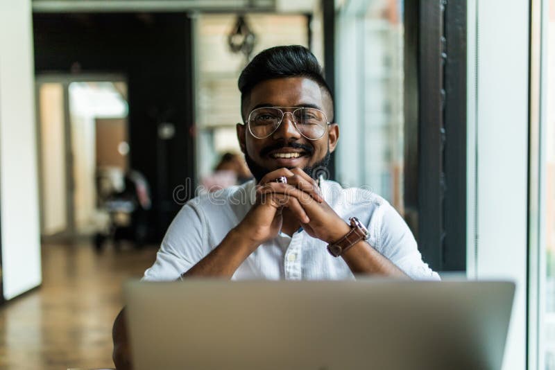Indian Man Using Laptop Computer while Drinking a Cup Hot Milk Tea ...