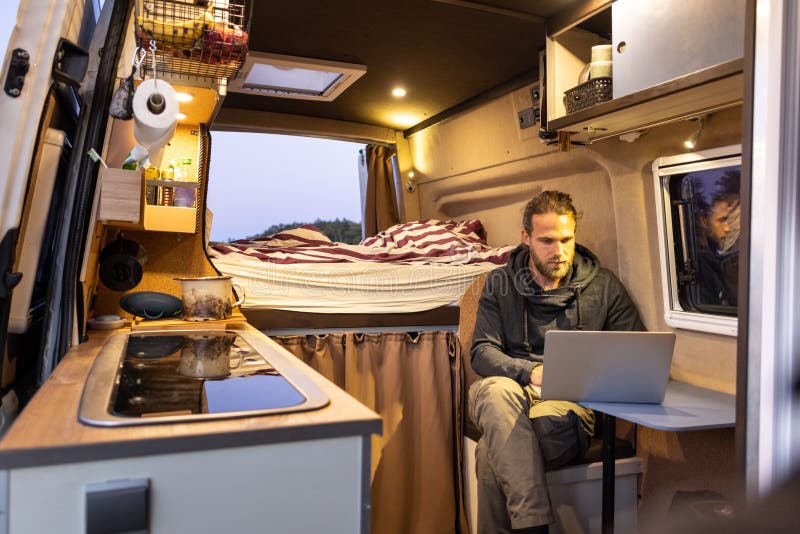 Man Using a Laptop Computer Inside His Camper Van Stock Photo - Image ...