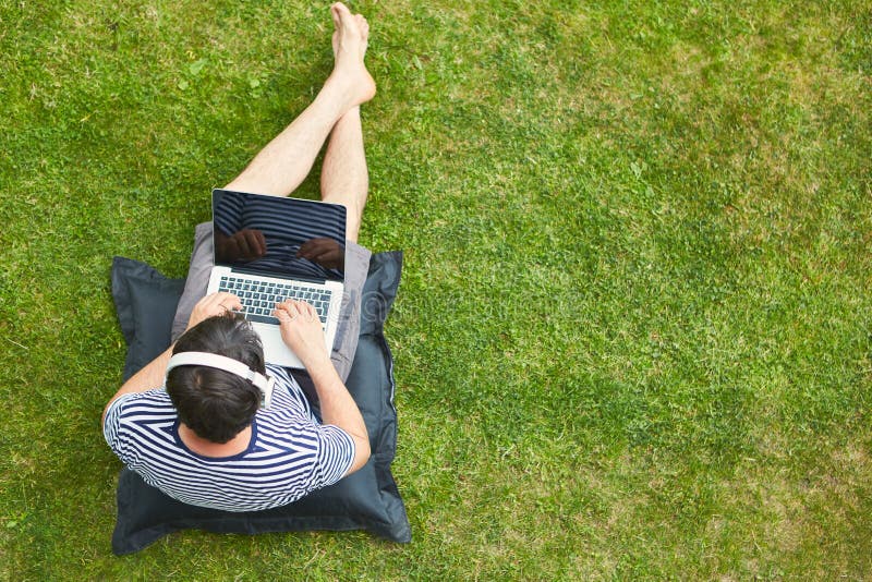 Man Using Laptop Computer on the Lawn in the Garden Stock Image - Image ...