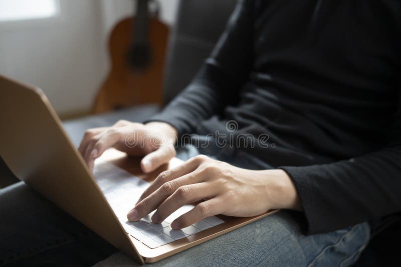 Man Using Laptop Computer while Sitting on Couch at Home. Stock Photo ...