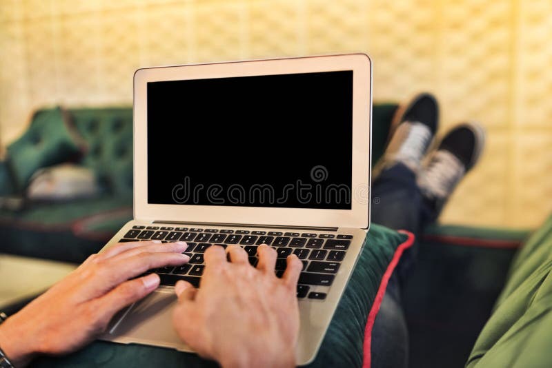 Man Using a Laptop on a Couch Stock Image - Image of selective, holding ...