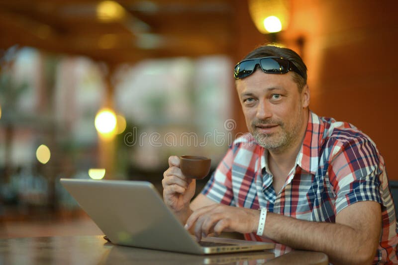 Man Using Laptop with Cup of Coffee Stock Image - Image of laptop ...
