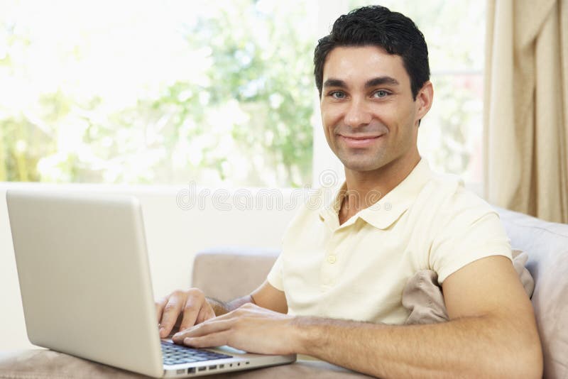 Man Using Laptop at Home stock image. Image of browsing - 12406019
