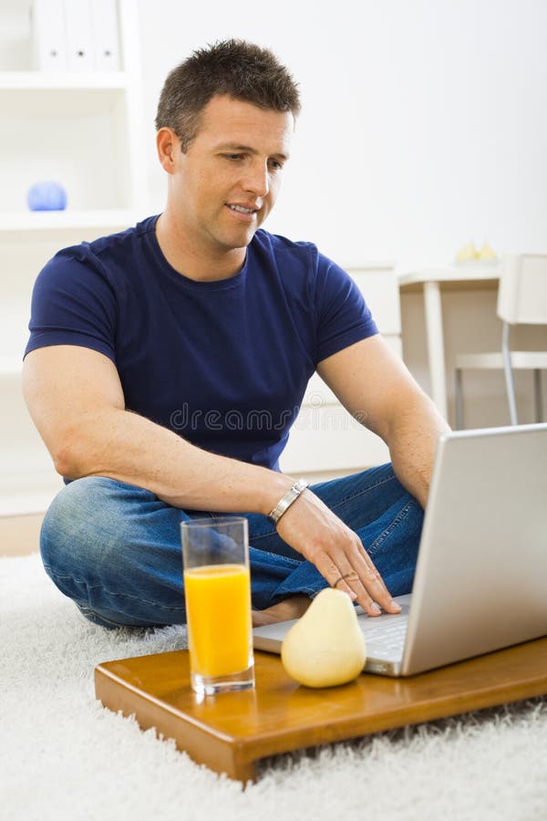 Man using laptop at home stock photo. Image of connectivity - 8883490