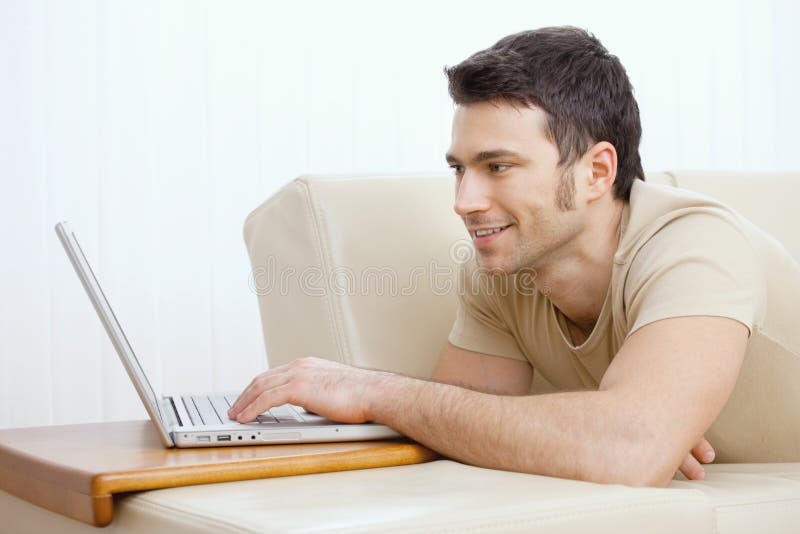 Man using laptop at home stock photo. Image of communication - 9101420