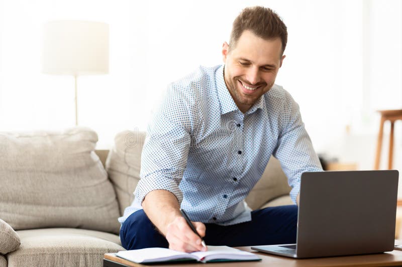 Man Using Laptop at Home and Writing Notes Stock Photo - Image of ...