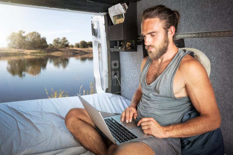 Man Using a Laptop Computer Inside His Camper Van Stock Photo - Image ...