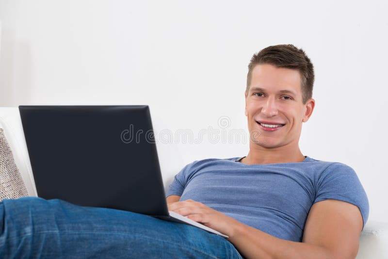 Man Using Laptop in Living Room Stock Photo - Image of adult, laptop ...