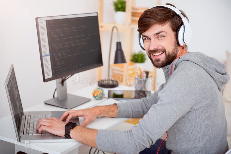 Man Using Laptop and Looking at Camera Stock Photo - Image of coding ...