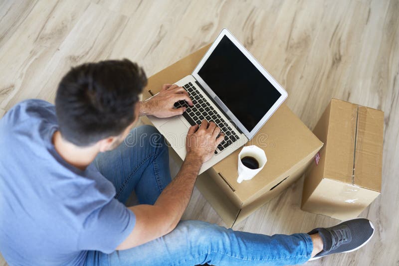 Man Using a Laptop Next To Moving Boxes Stock Photo - Image of life ...